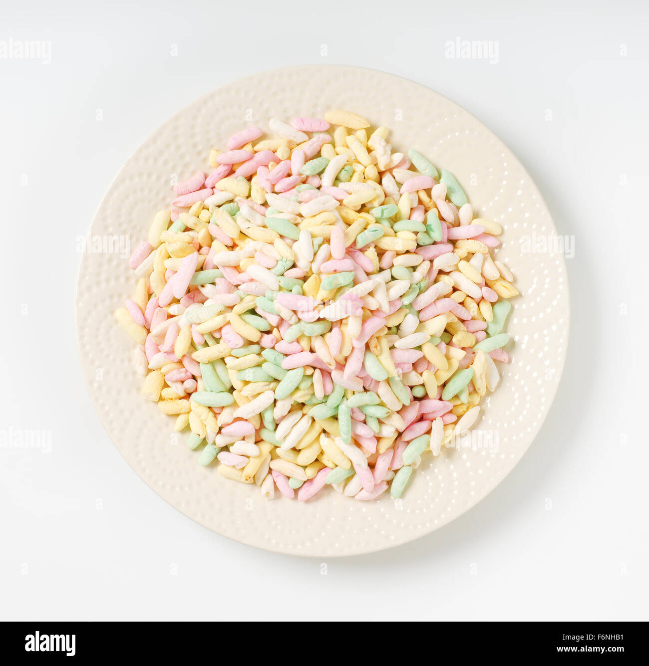 plate of colorful puffed rice on white background Stock Photo - Alamy