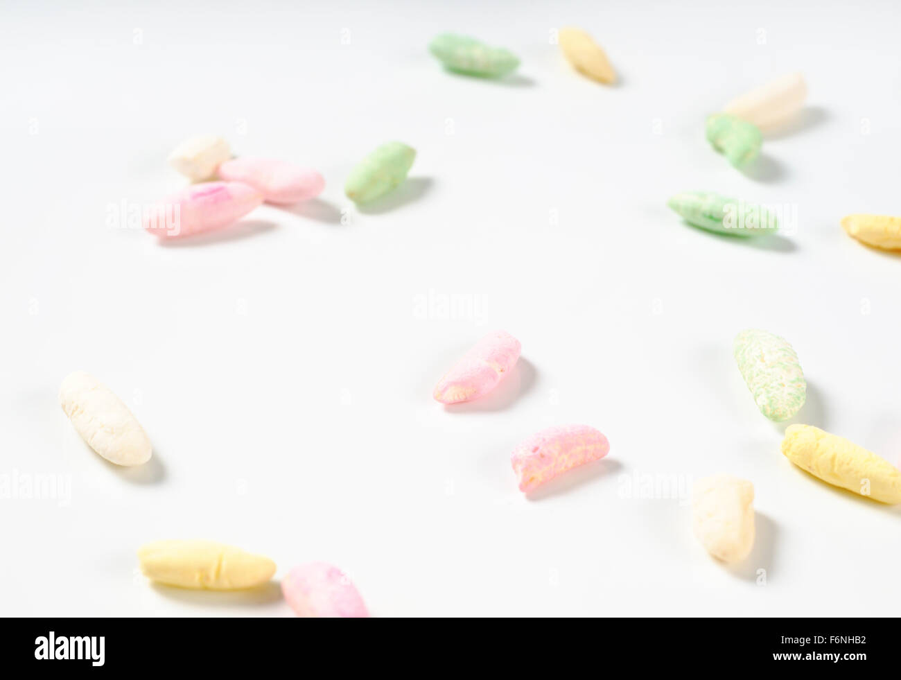 colorful puffed rice spread on white background Stock Photo - Alamy