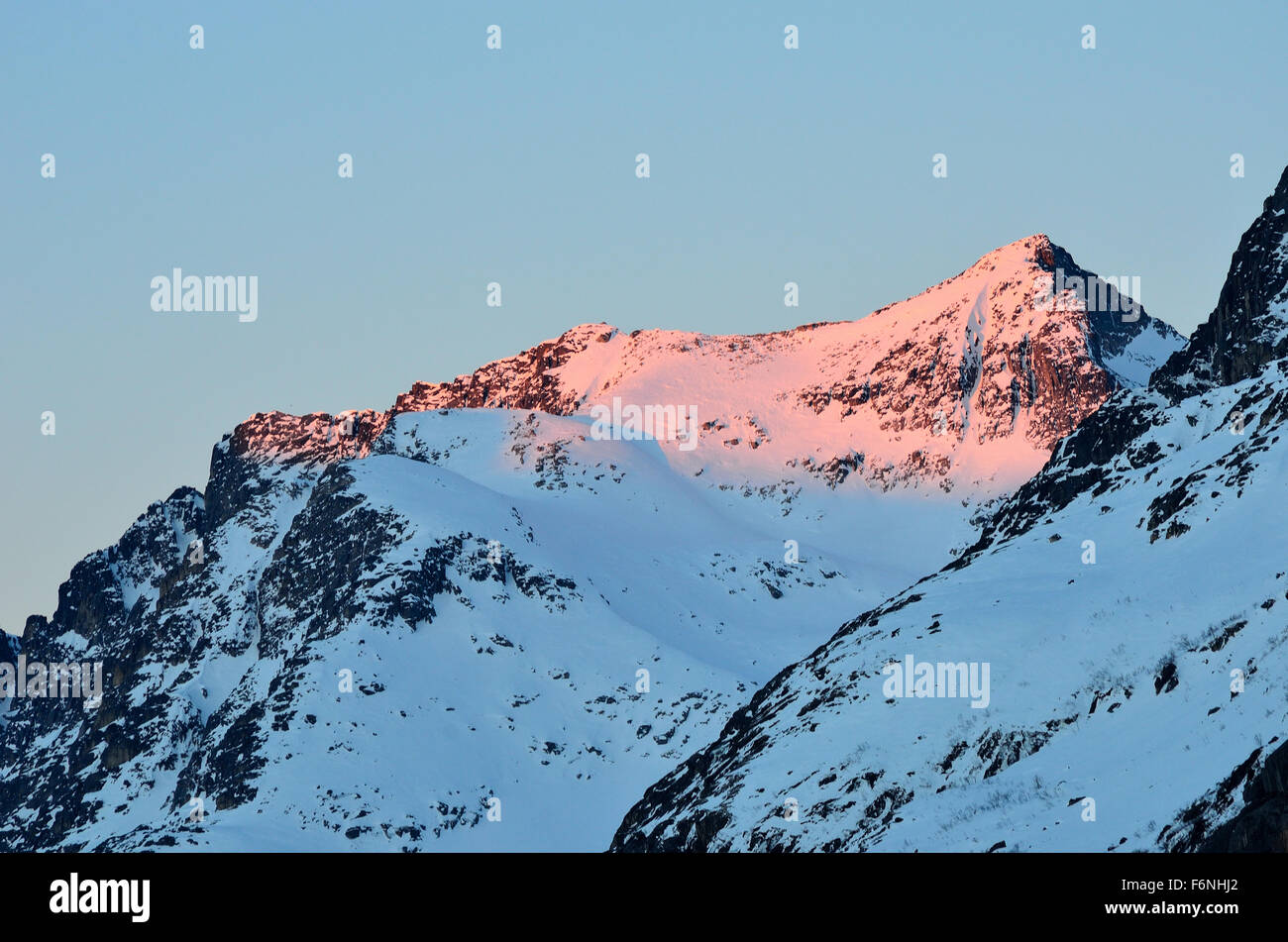 First sunshine on snowy mountain top Stock Photo - Alamy