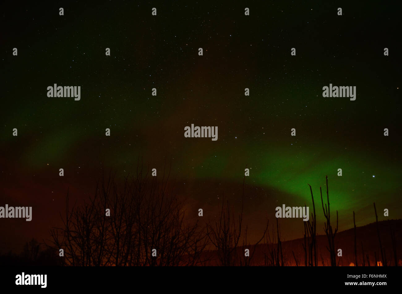 aurora borealis, northern light on a fire red sky in the arctic circle ...