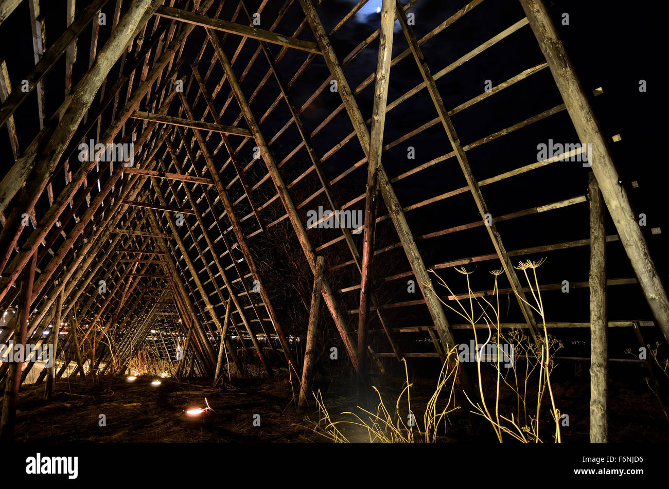 beautiful old illuminated wooden stockfish structure at night time ...