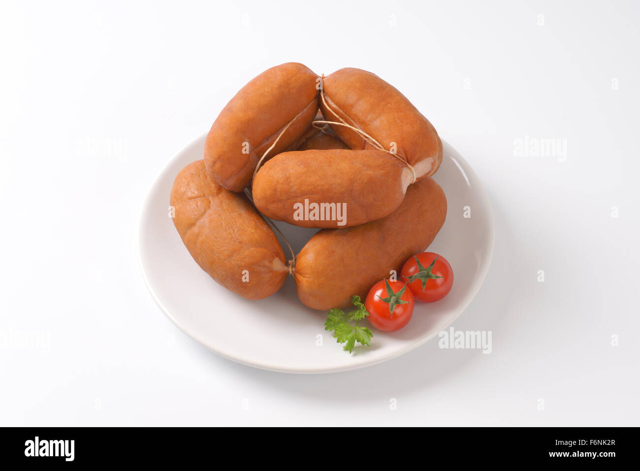 chain of raw wurst sausages on white plate Stock Photo - Alamy