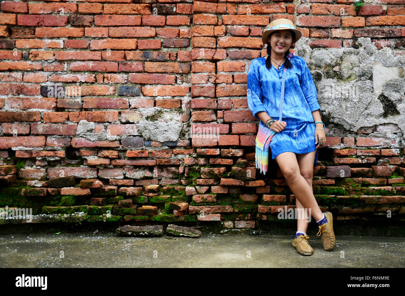 Thai woman portrait at Brick wall Background of Wat Yai chaimongkol in ...