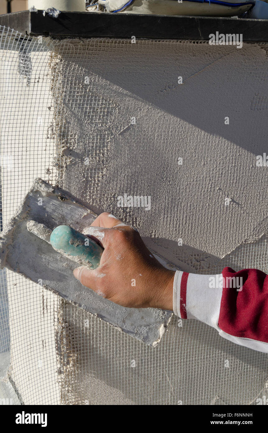 workman during the laying of a reinforcing mesh for plaster Stock Photo ...