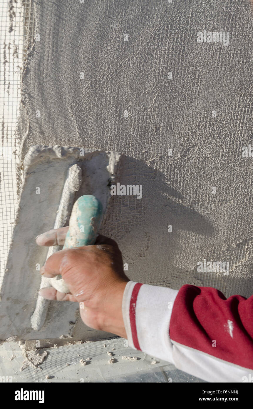workman during the laying of a reinforcing mesh for plaster Stock Photo ...
