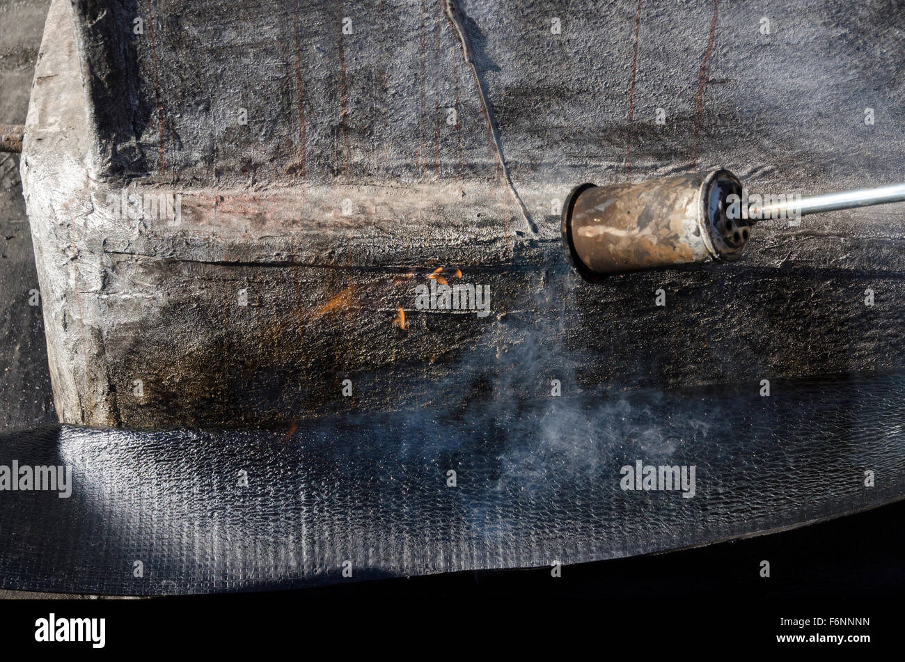 flame during welding of a waterproofing membrane on a roof Stock Photo ...