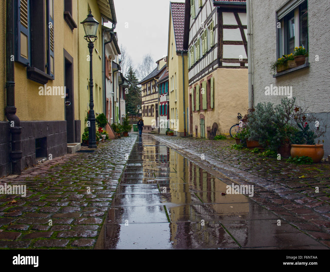 Wet cobbled street in Ettlingen Germany with person in distance Stock ...