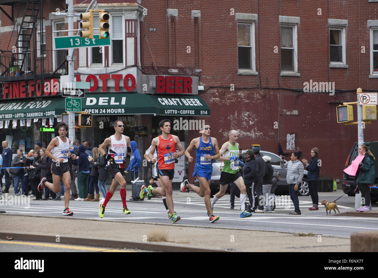 Runners race up 4th Avenue through Park Slope Brooklyn during the 1st ...