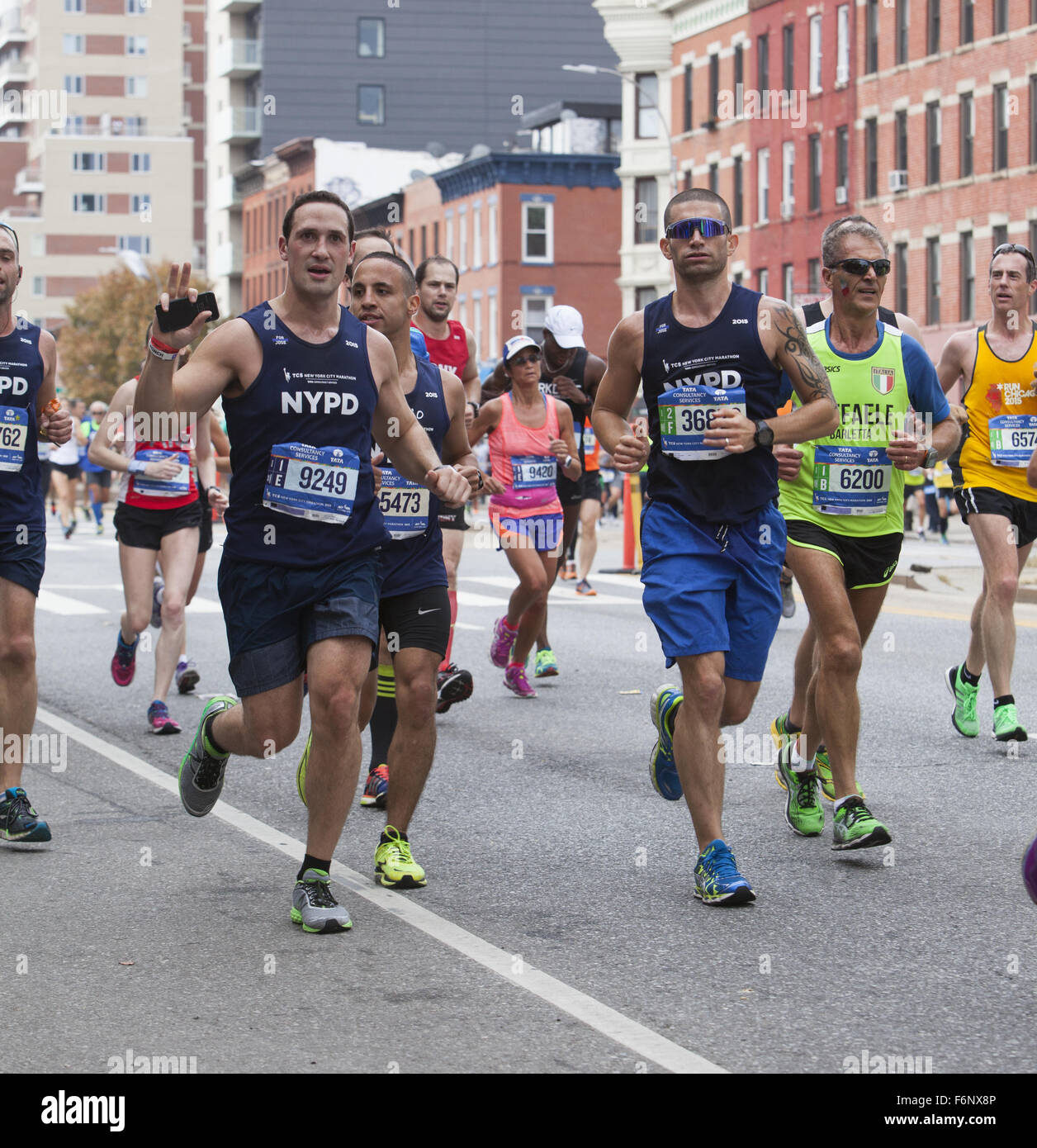 Runners race up 4th Avenue through Park Slope Brooklyn during the 1st ...