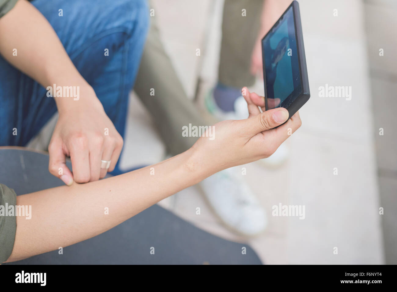Close up on the hand of a young man holding a smartphone, watching a ...