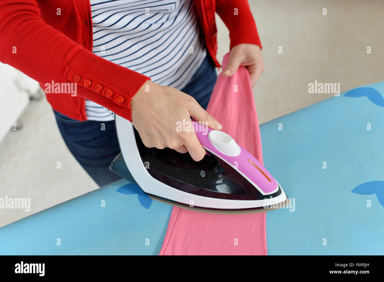 A dark-haired woman ironing Stock Photo - Alamy