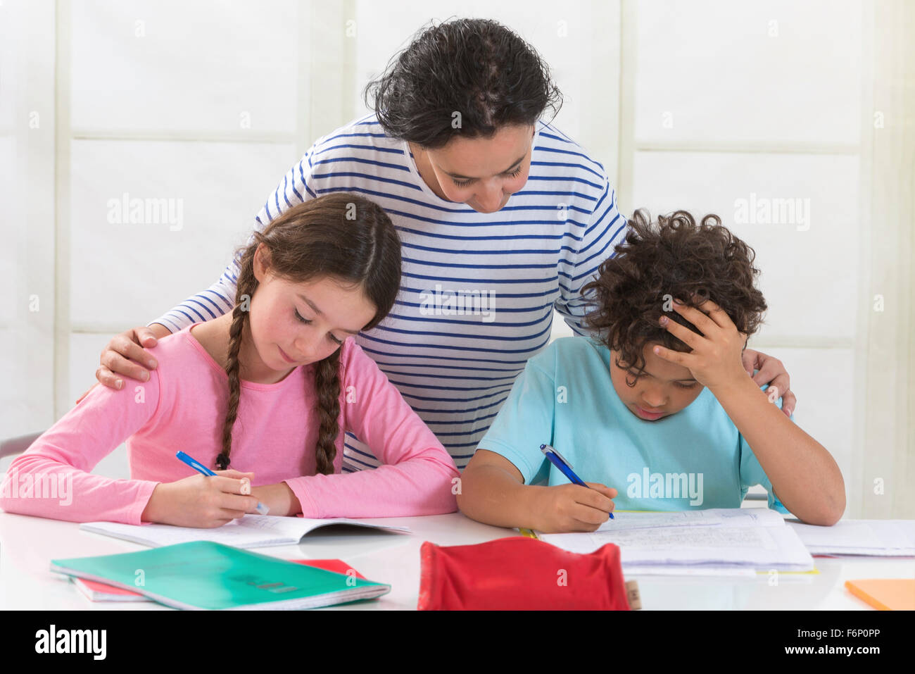 Kids helping at homework hi-res stock photography and images - Alamy