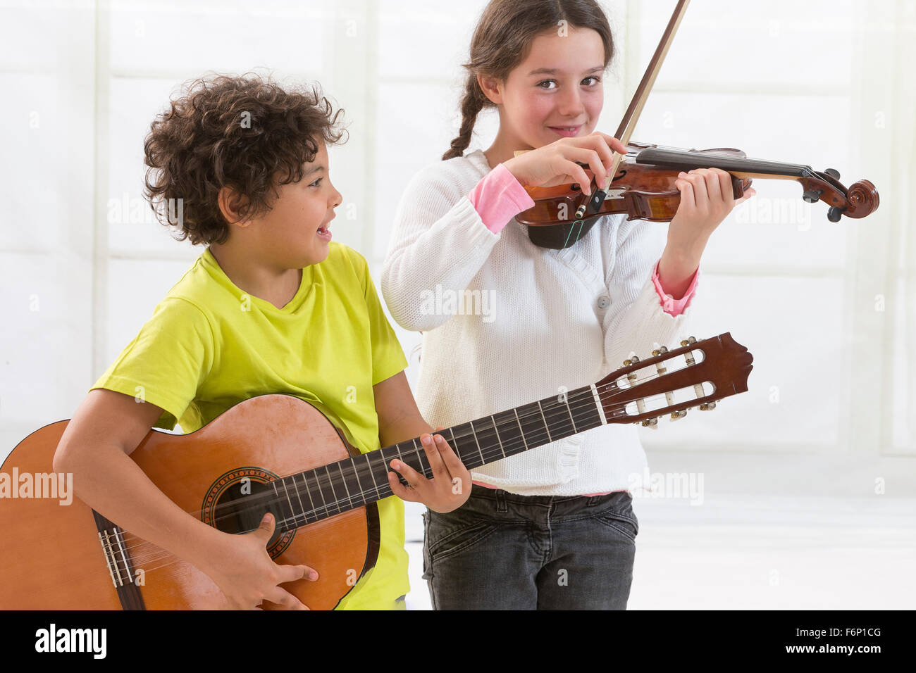 Sister and Brother playing music Stock Photo - Alamy