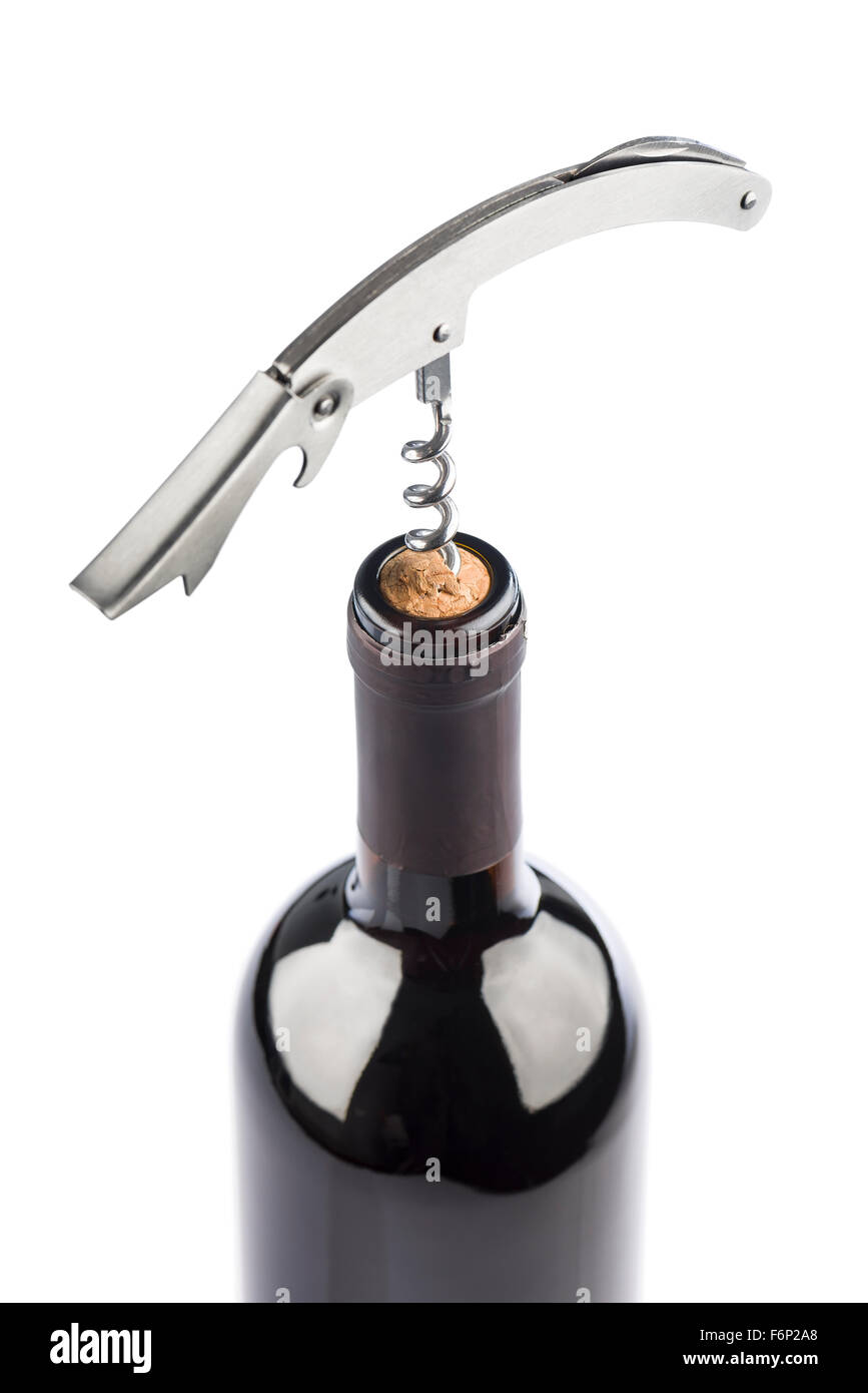 corkscrew inserted on cork into red wine bottle, isolated on white ...