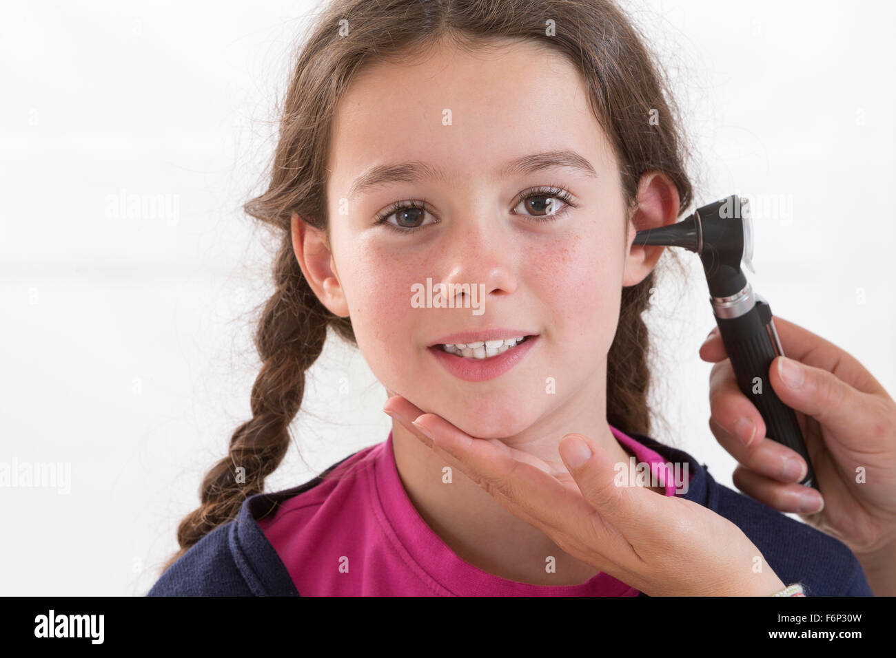 Cute little girl attending a medical check-up Stock Photo - Alamy