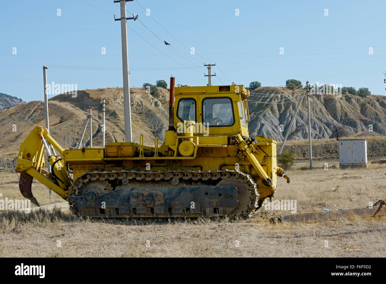 Yellow dozer with single-tooth ripper is at pipeline building place in ...