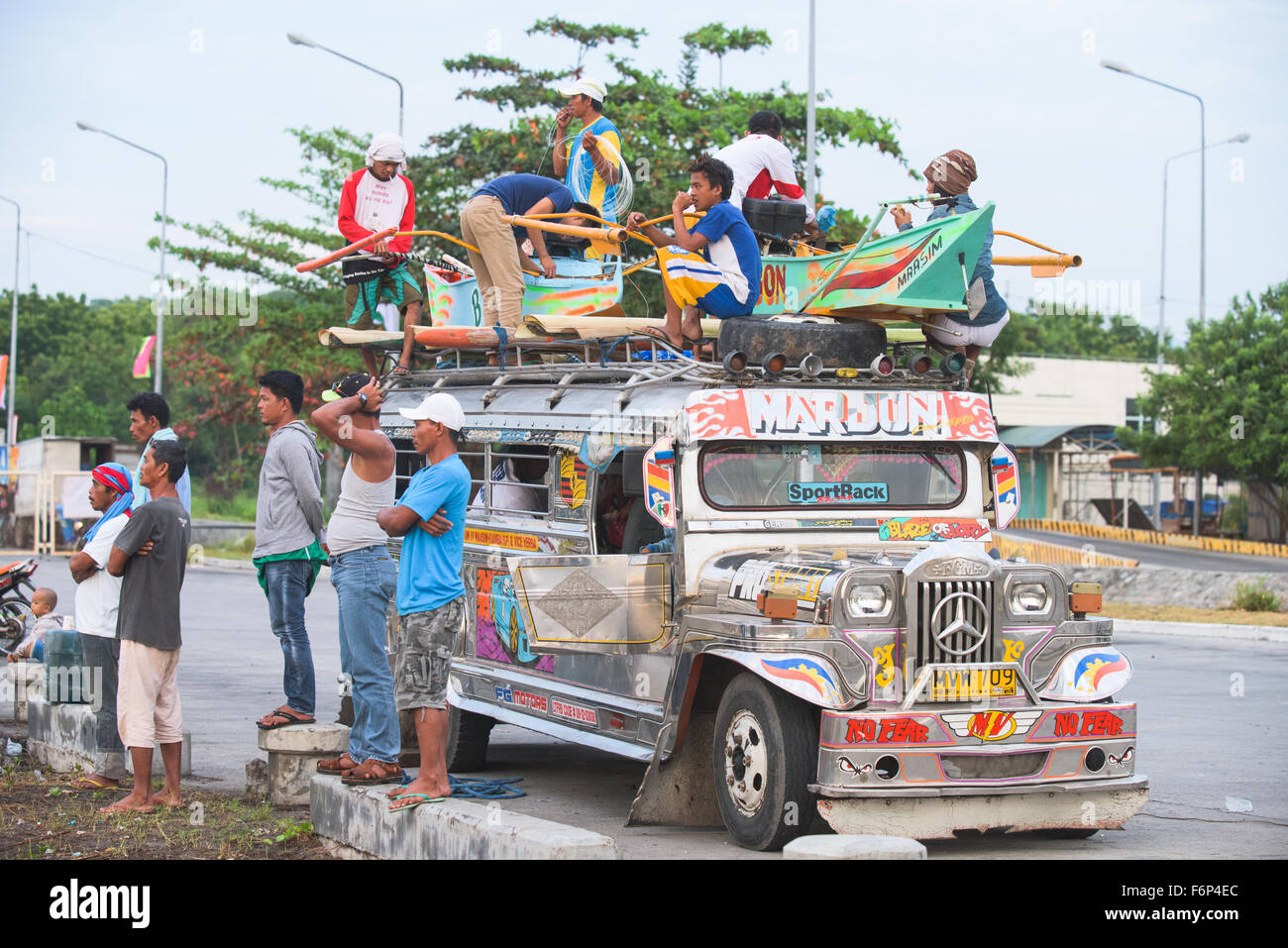 Jeepney with two bancarera boats on top, being prepared for the annual ...