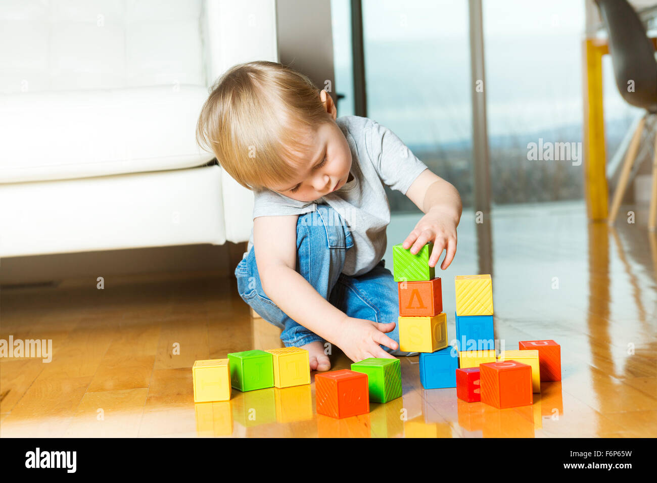 kid playing toy blocks inside his house Stock Photo - Alamy