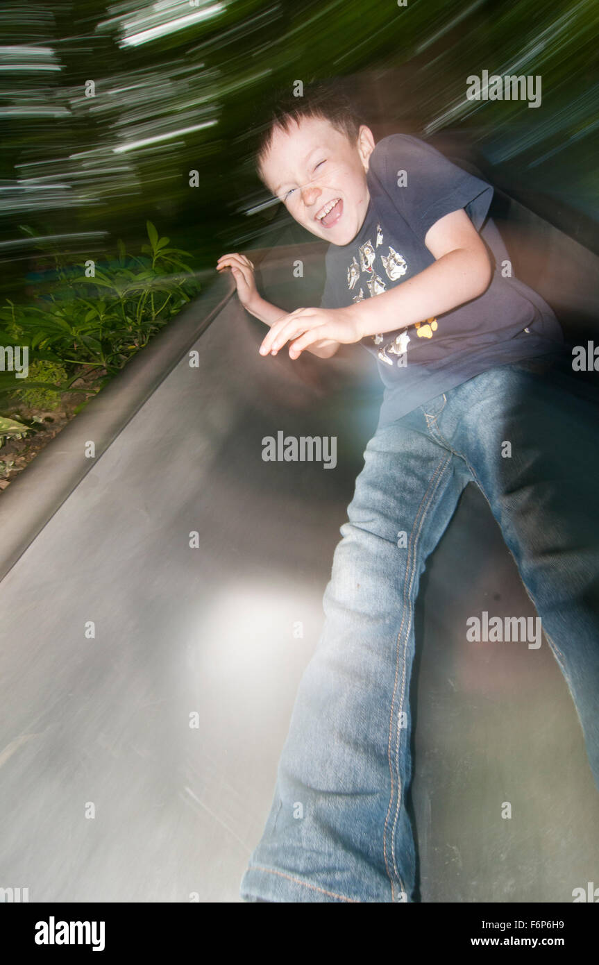 Boy coming down slide hi-res stock photography and images - Alamy