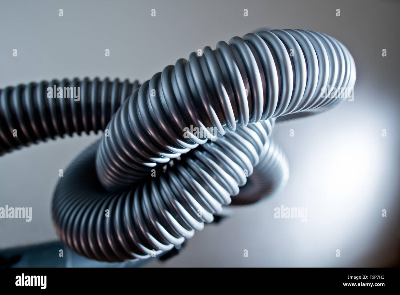 a detail of plastic tube on the gray background Stock Photo - Alamy