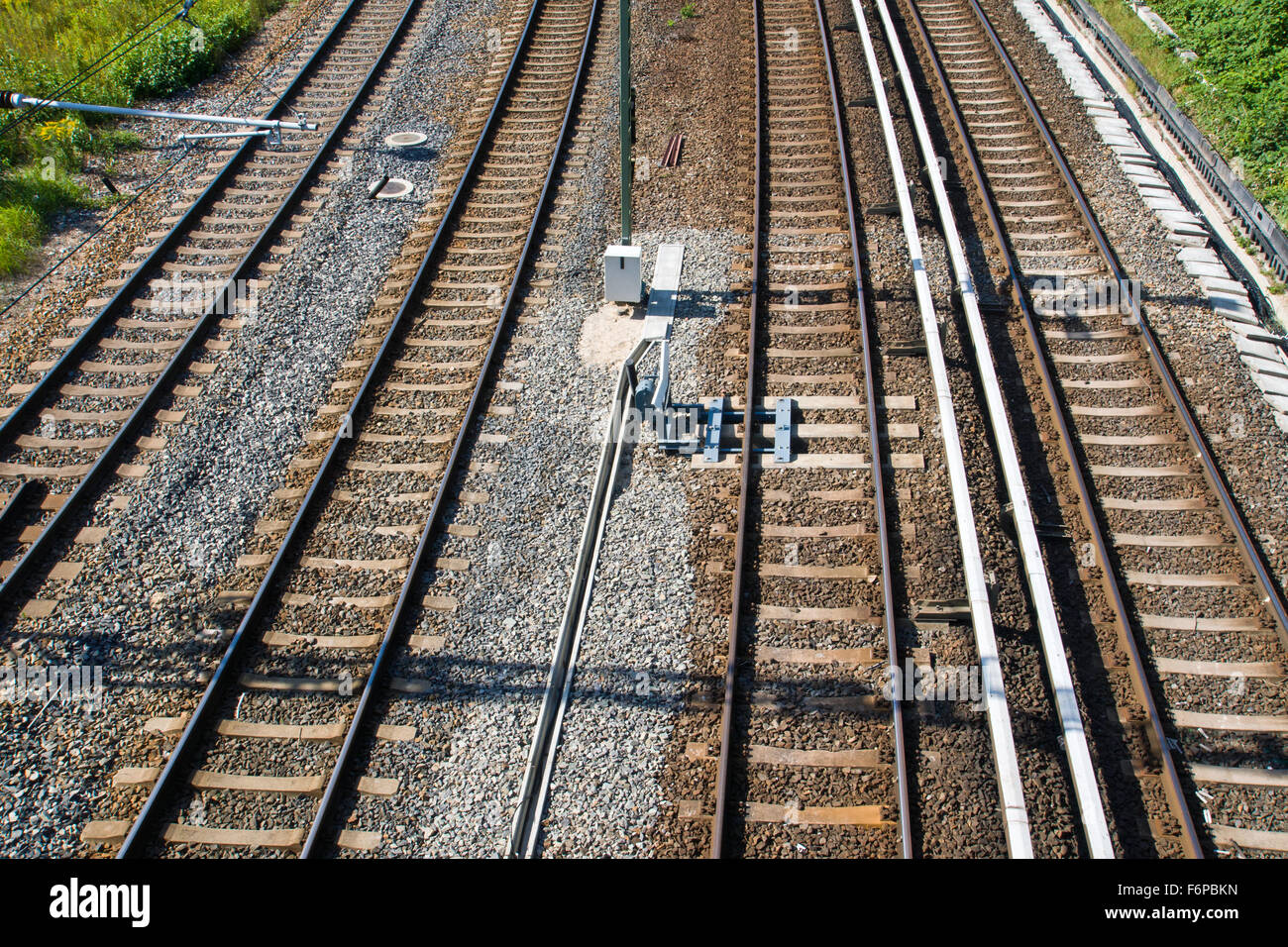 Four railroad tracks seen from a bridge Stock Photo - Alamy