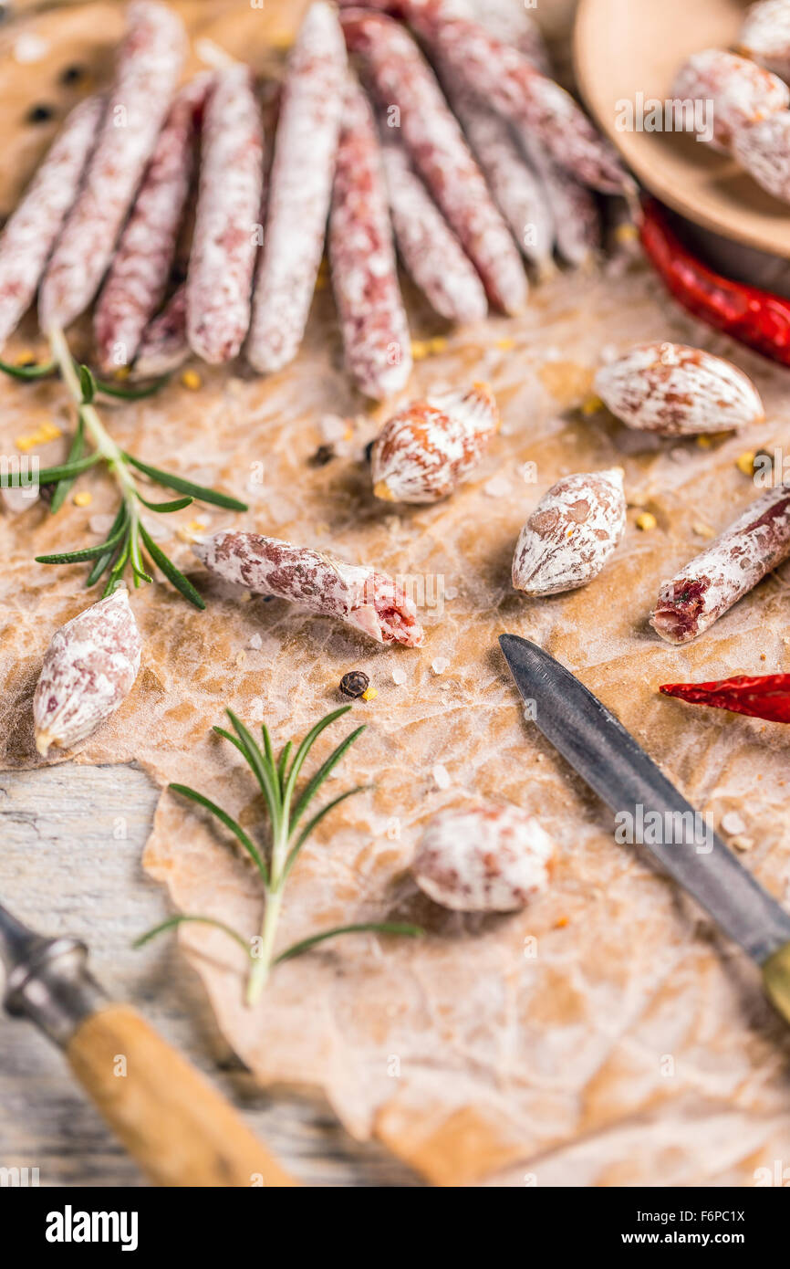 Salami composition on rustic paper Stock Photo - Alamy