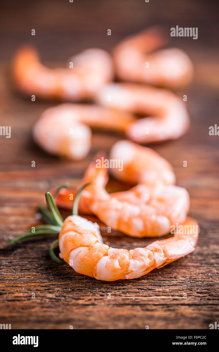 Raw prawns on wooden background Stock Photo - Alamy