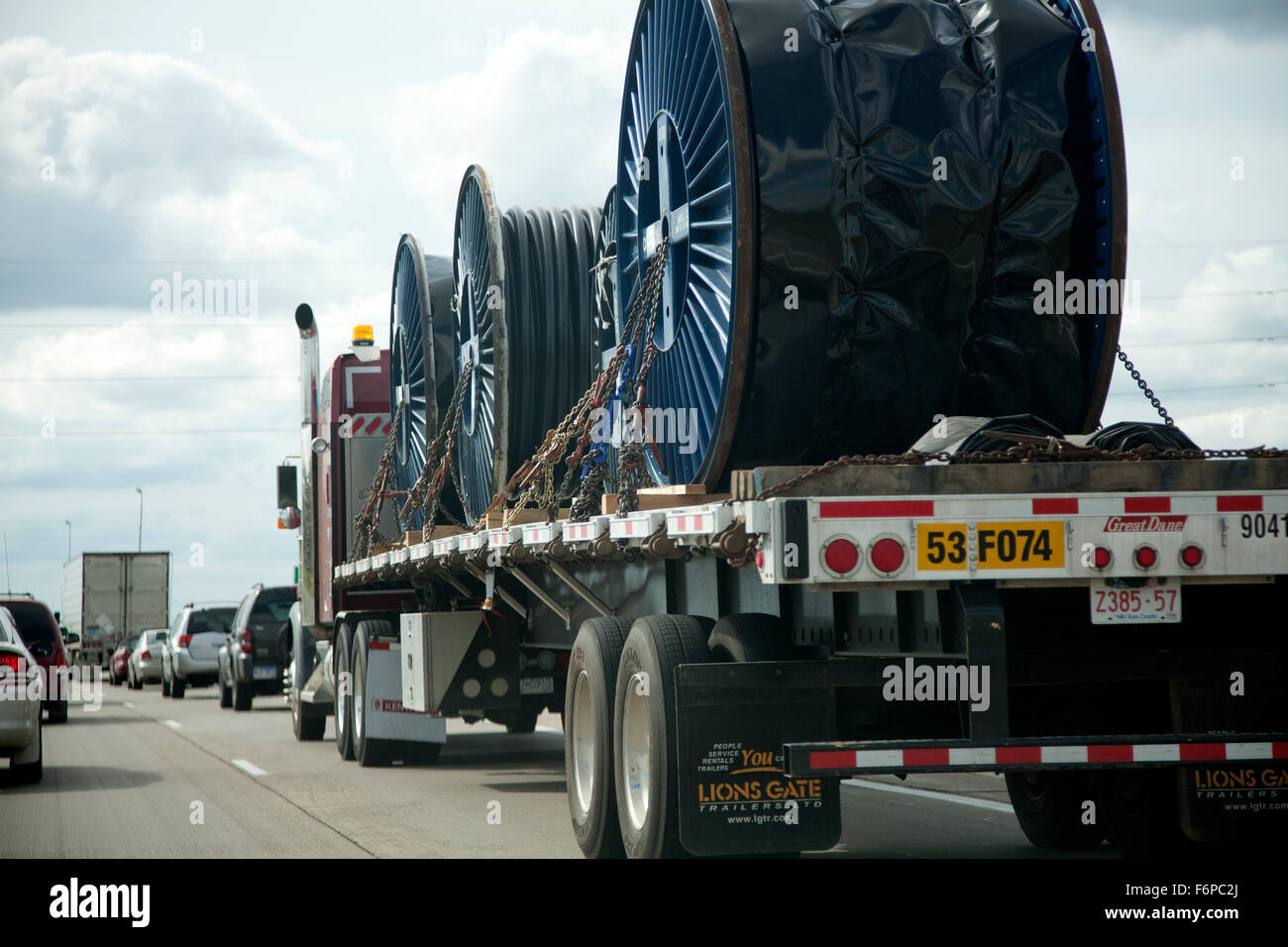 Large rolls of electronic cable being transported by semi flatbed ...
