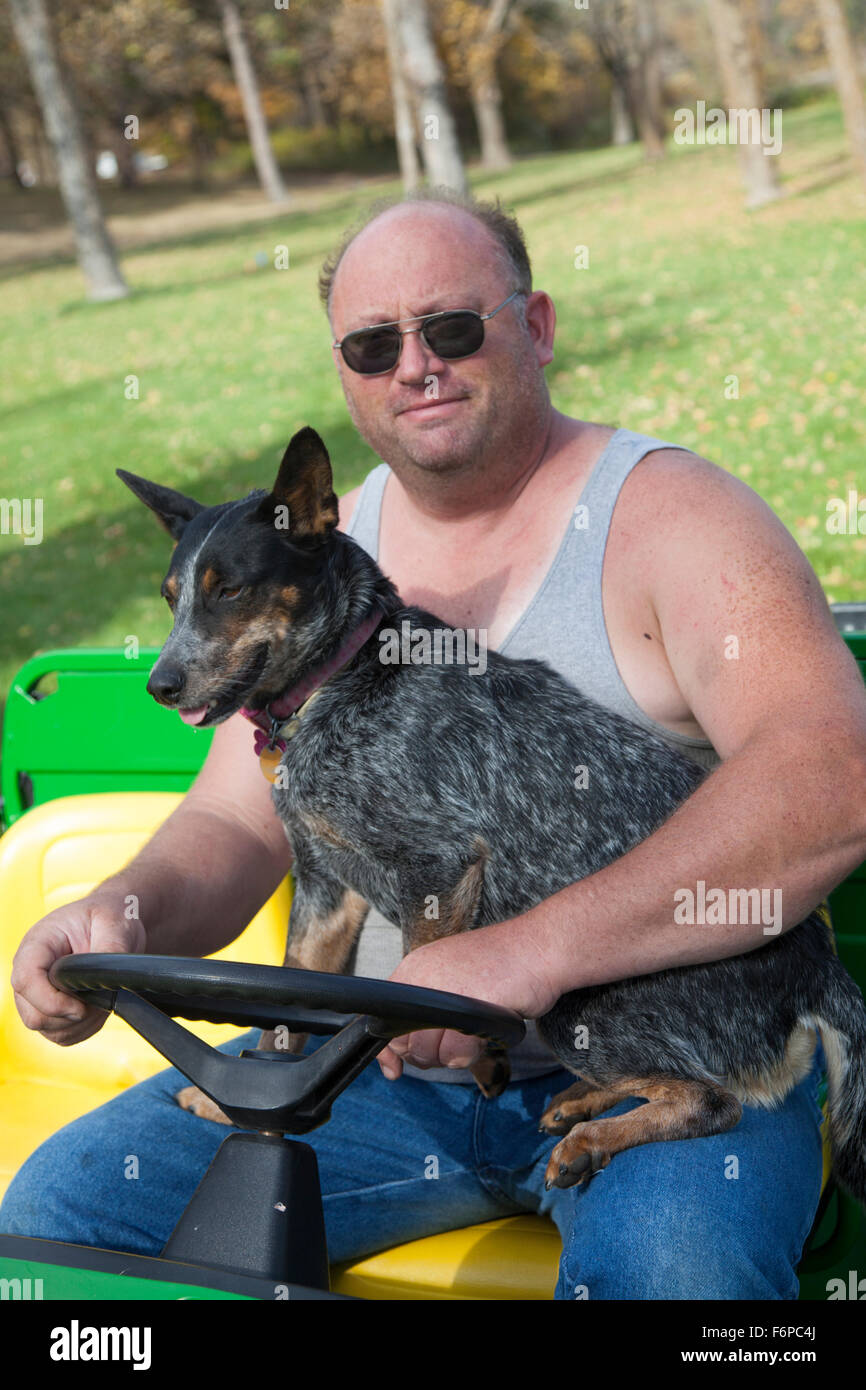Man with dog on his lap hi-res stock photography and images - Alamy