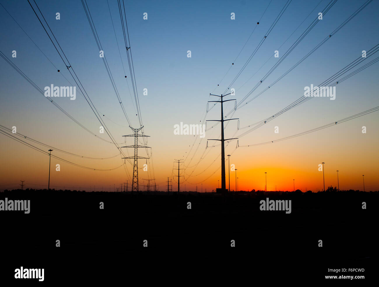 Silhouettes of power transmission line poles and system of cables ...