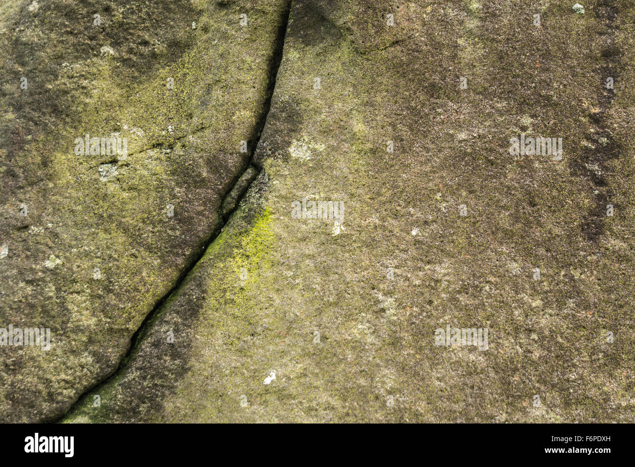 Natural weathered volcanic igneous rock background with central split ...