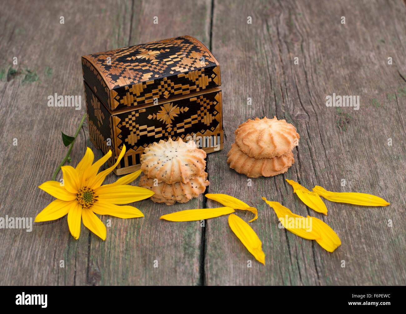 casket, two linking of cookies and yellow flower Stock Photo - Alamy