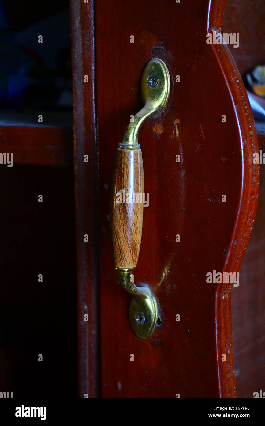 Cupboard Golden Handle embedded with hard-wood Stock Photo - Alamy