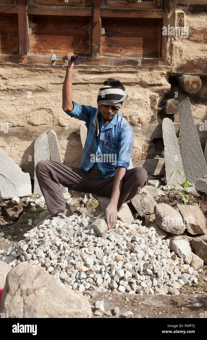 Indian labourer breaking stones in the village of Chitkul, the last ...