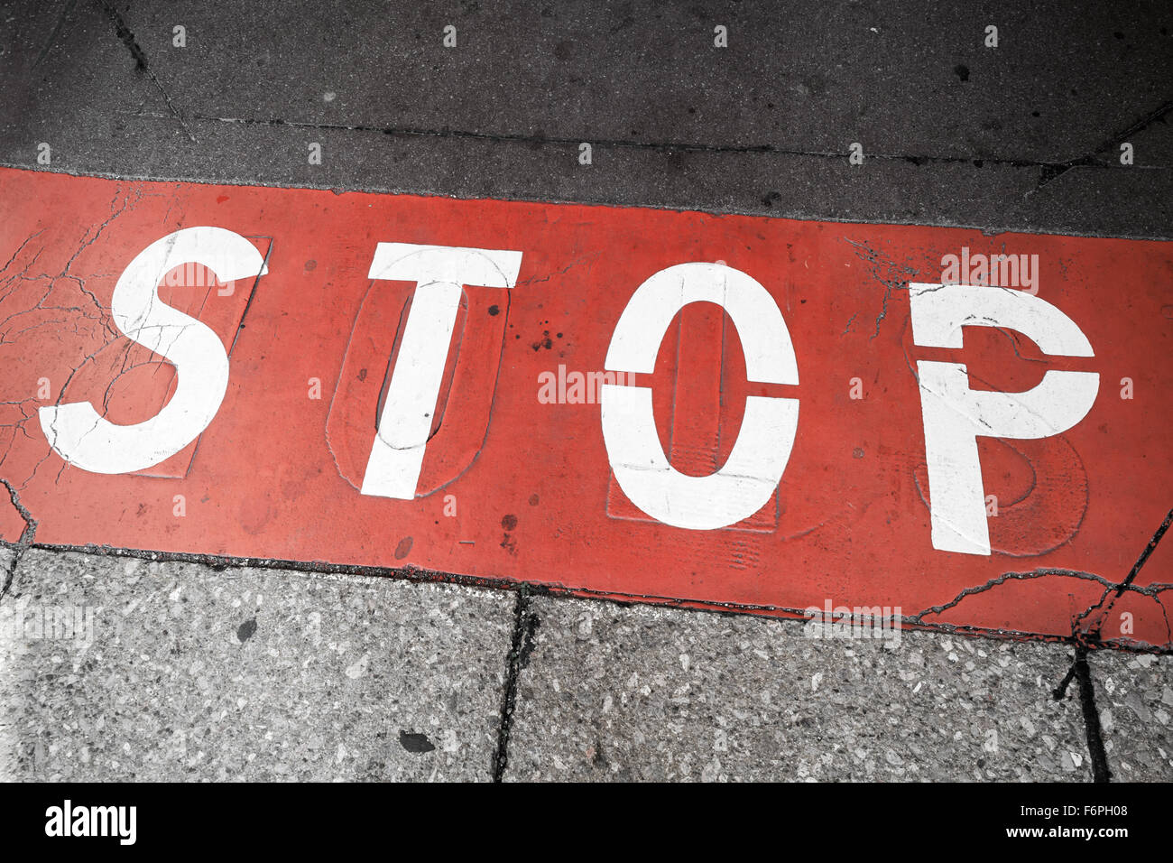 Road marking with stop label over red line on urban pavement Stock ...