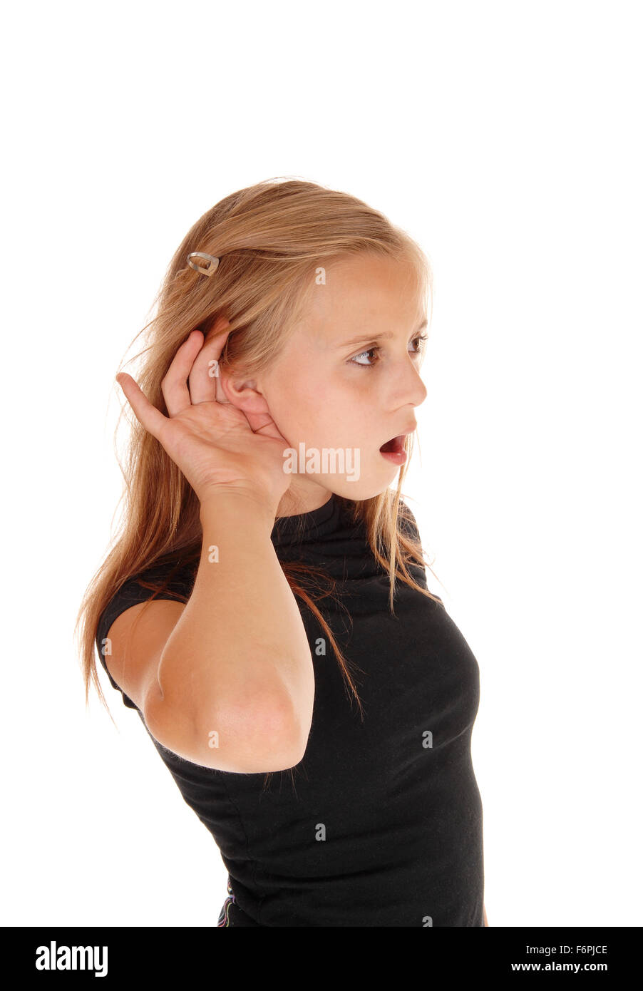 A blond young girl in a black top with one hand behind her ear can not ...