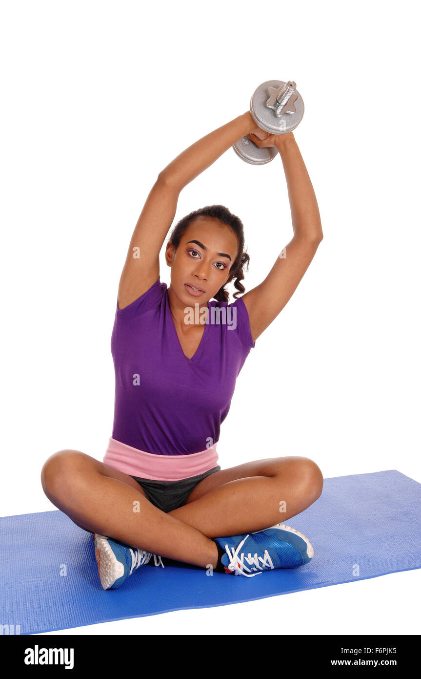 A beautiful young African American woman in a violet top and shorts ...