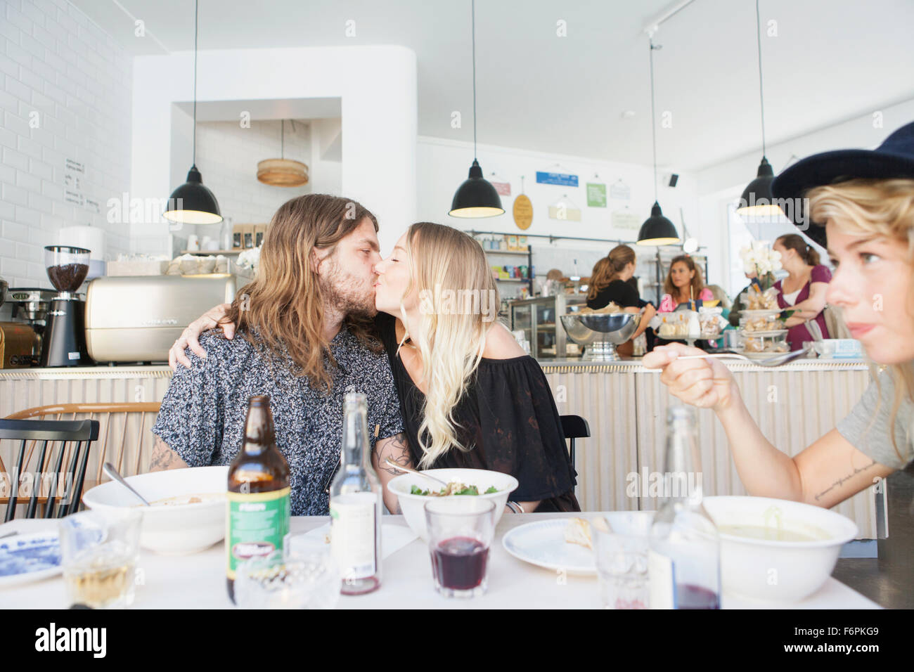 Couple Sitting In Restaurant Kissing Stock Photos & Couple Sitting In ...