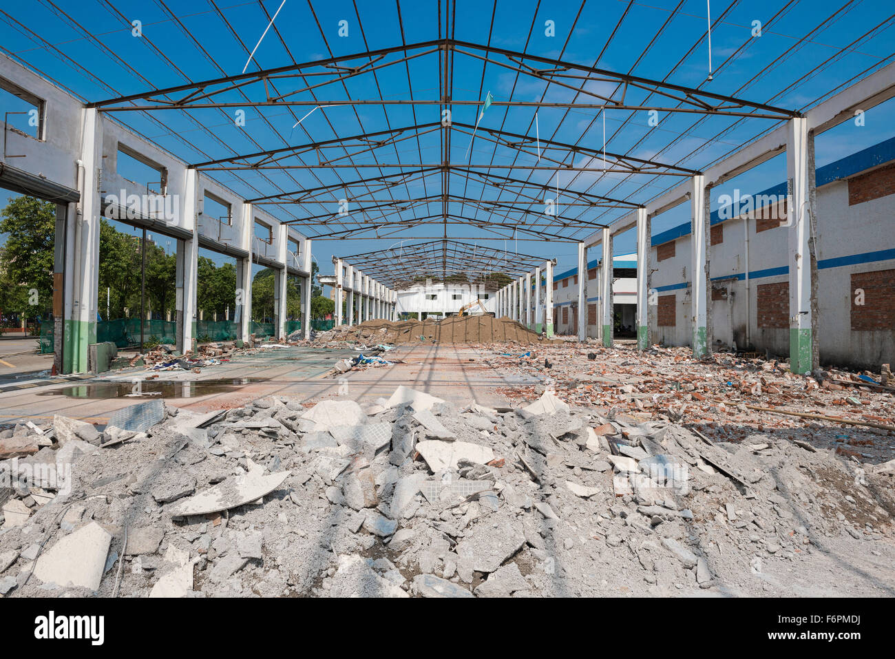 Demolition of an old factory building under blue sky Stock Photo - Alamy