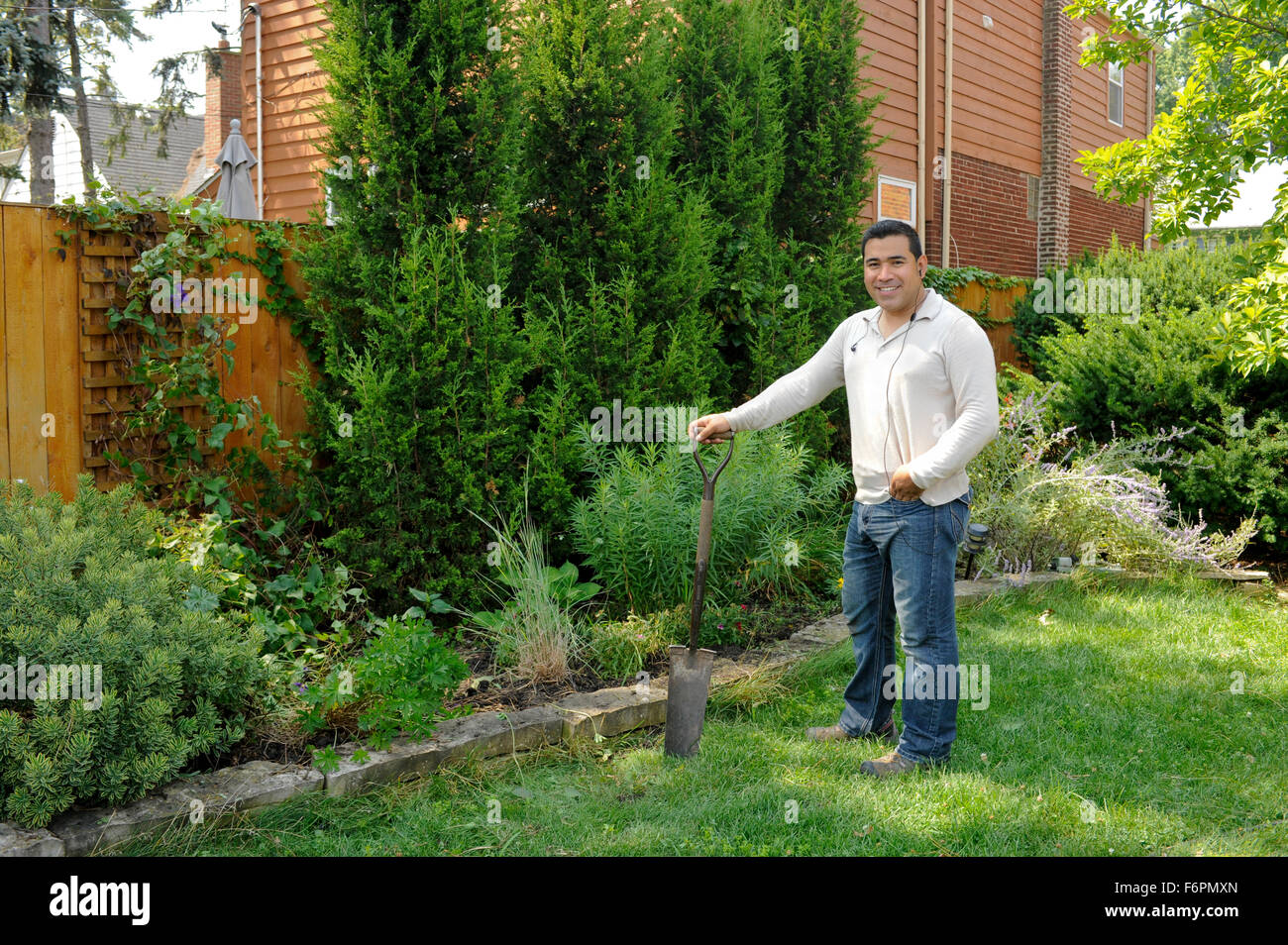 Mexican man working in flower garden Stock Photo - Alamy