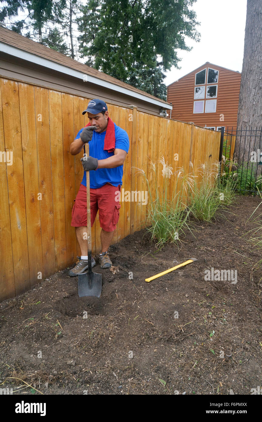 Mexican man working in garden with tools Stock Photo - Alamy
