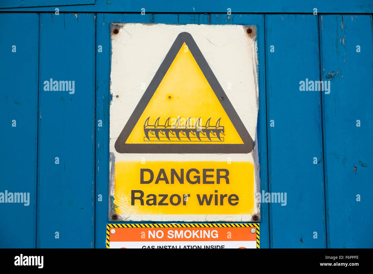 warning sign for razor wire Stock Photo - Alamy