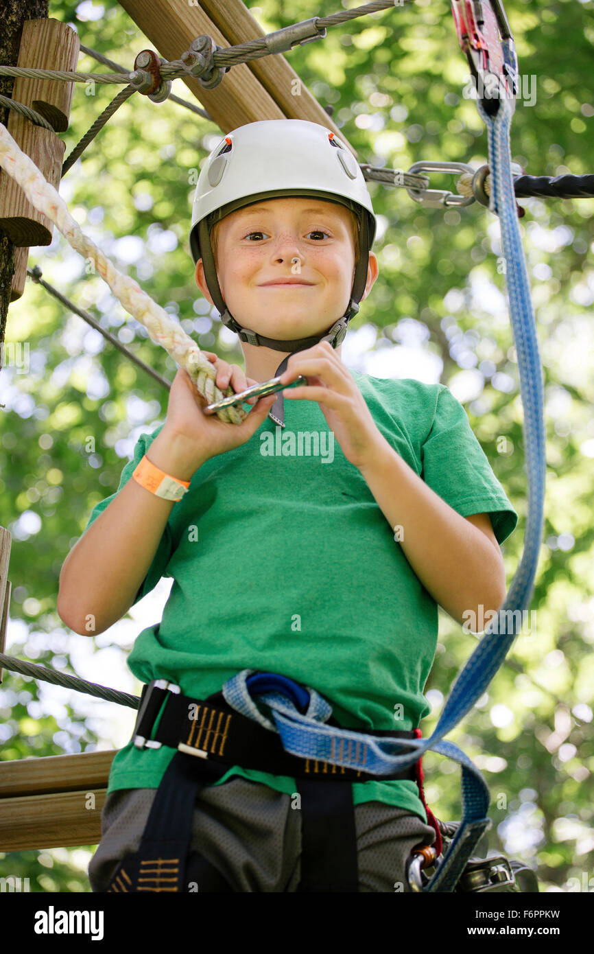 Caucasian boy hooking harness to line Stock Photo - Alamy