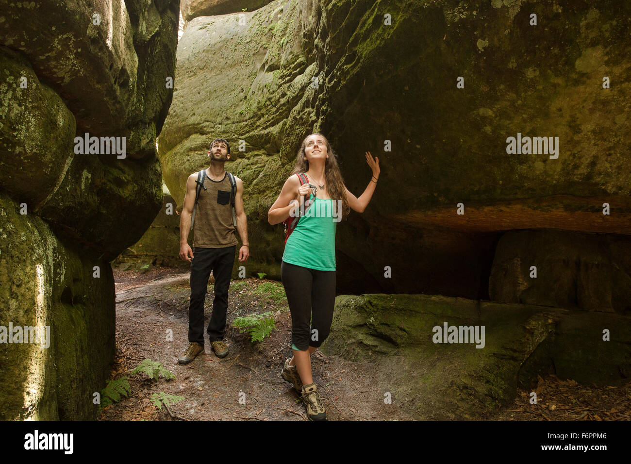 Caucasian couple exploring cave Stock Photo - Alamy