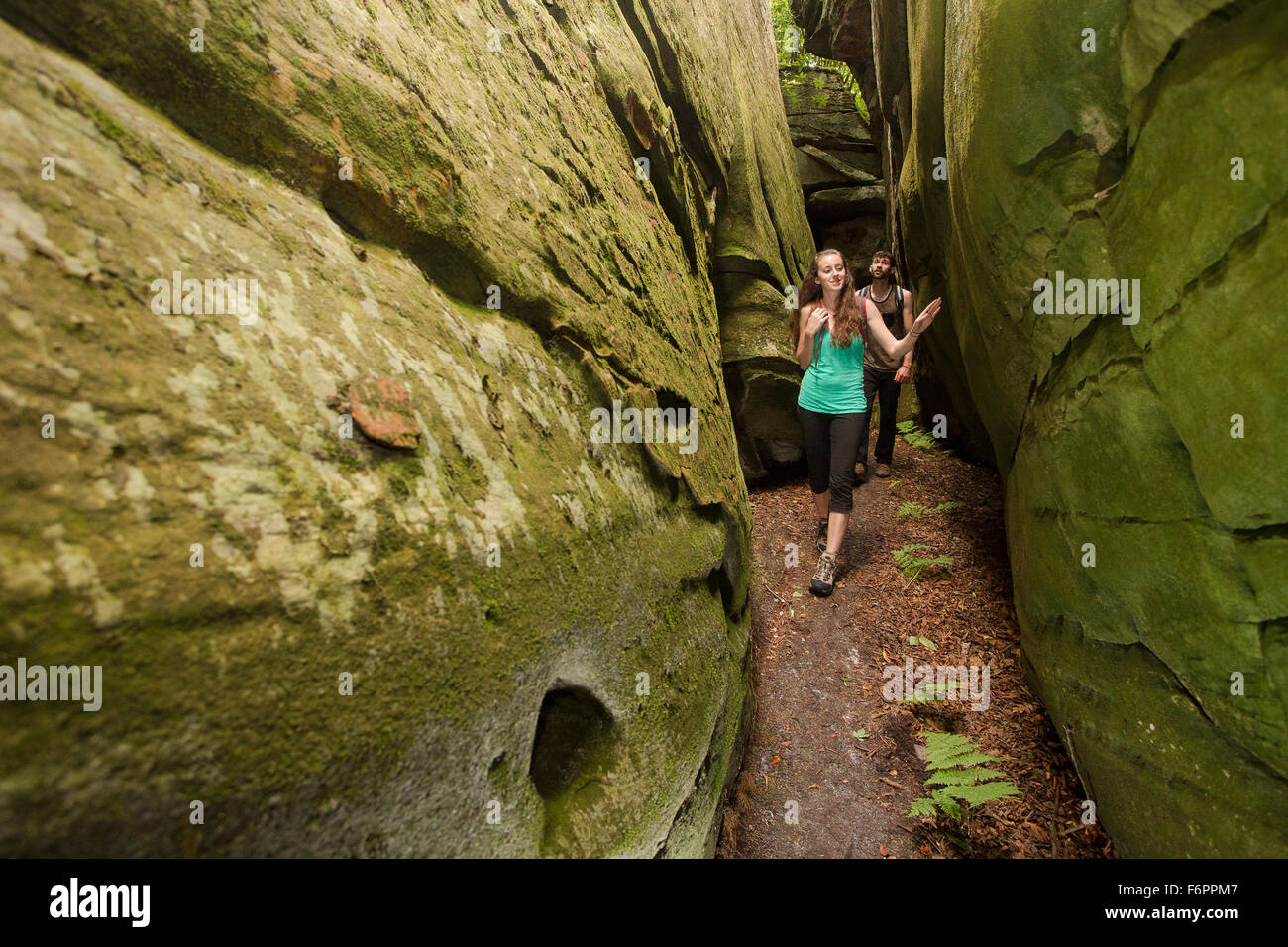 Caucasian couple exploring cave Stock Photo - Alamy
