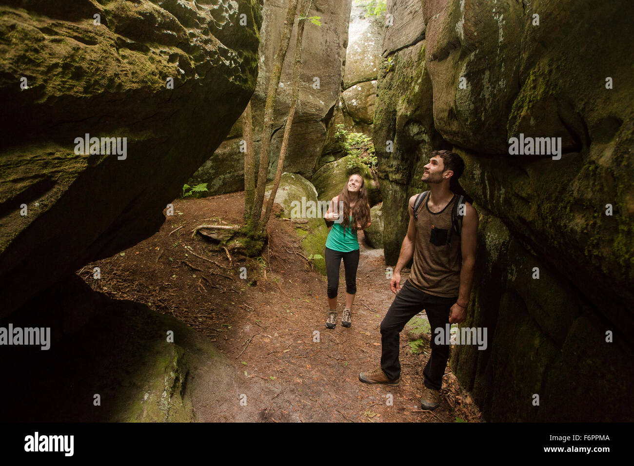 Caucasian couple exploring cave Stock Photo - Alamy