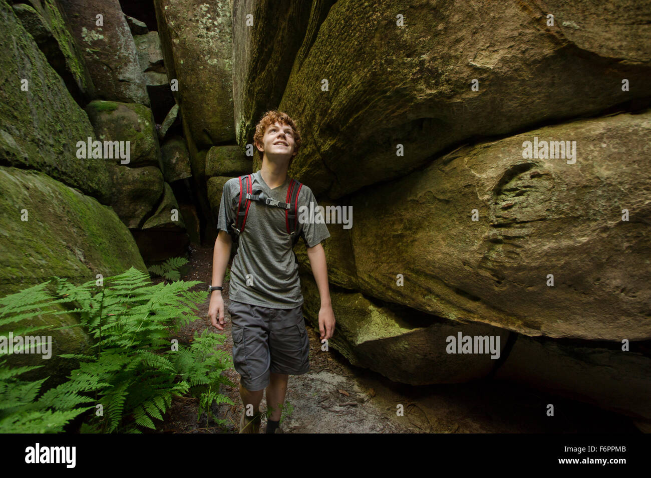 Caucasian teenage boy exploring cave Stock Photo - Alamy