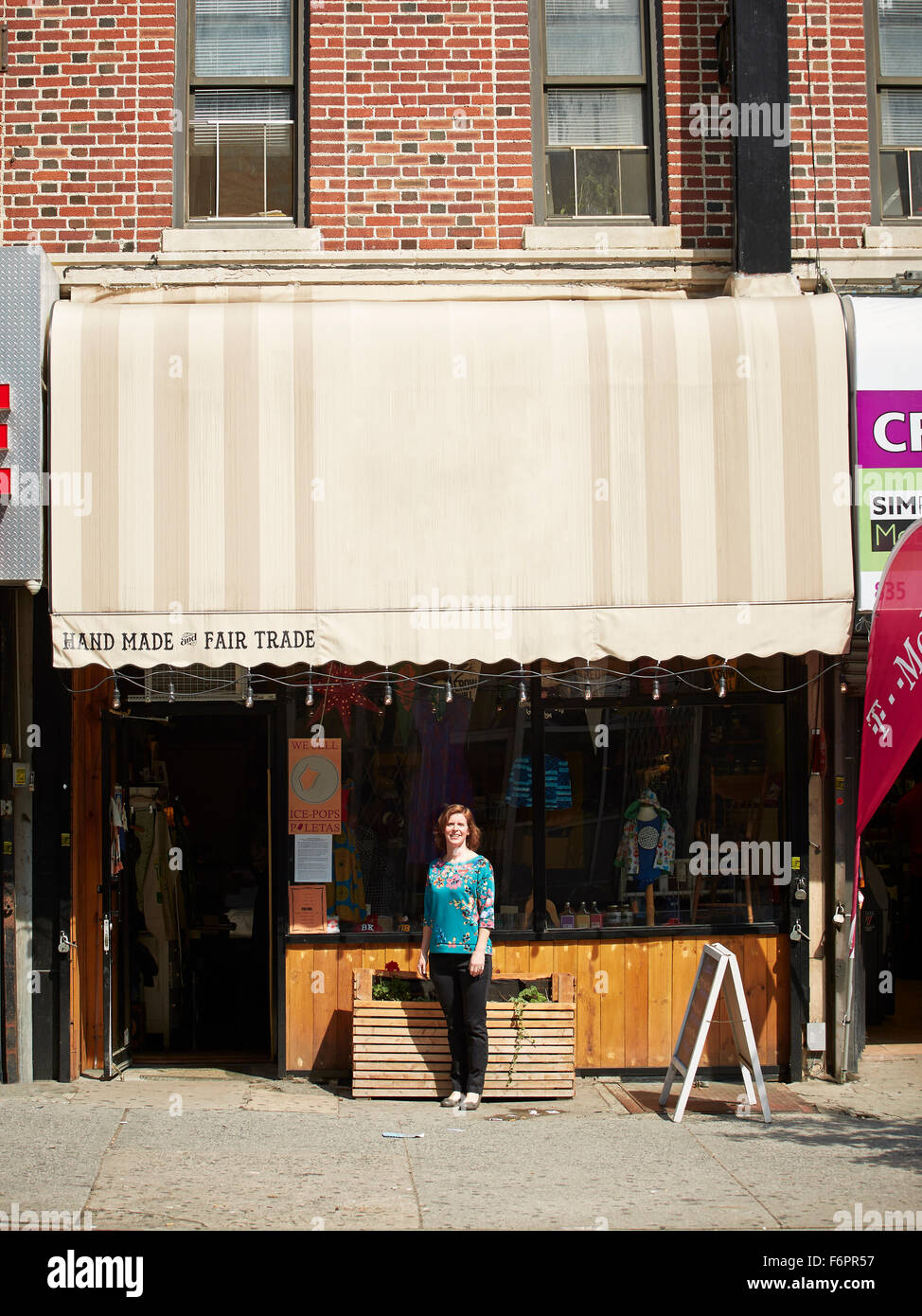 Caucasian woman standing outside store Stock Photo - Alamy