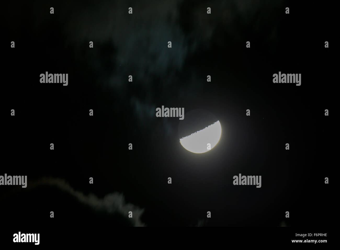 Clouds move past the half-moon on an autumn night in Indiana. lunar ...