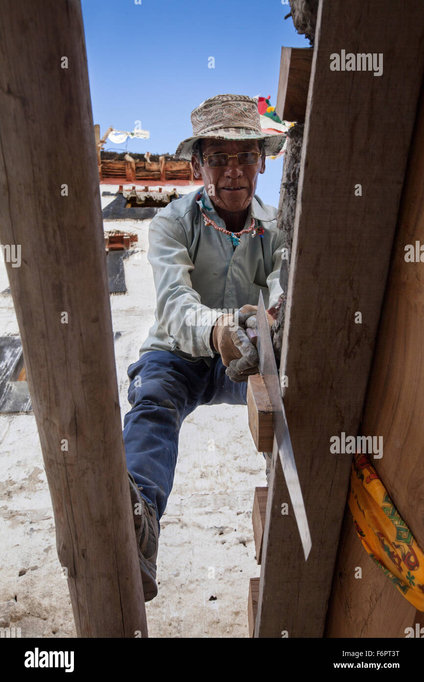 Carpenter working on restoration of Tenth century Buddhist monastery at ...